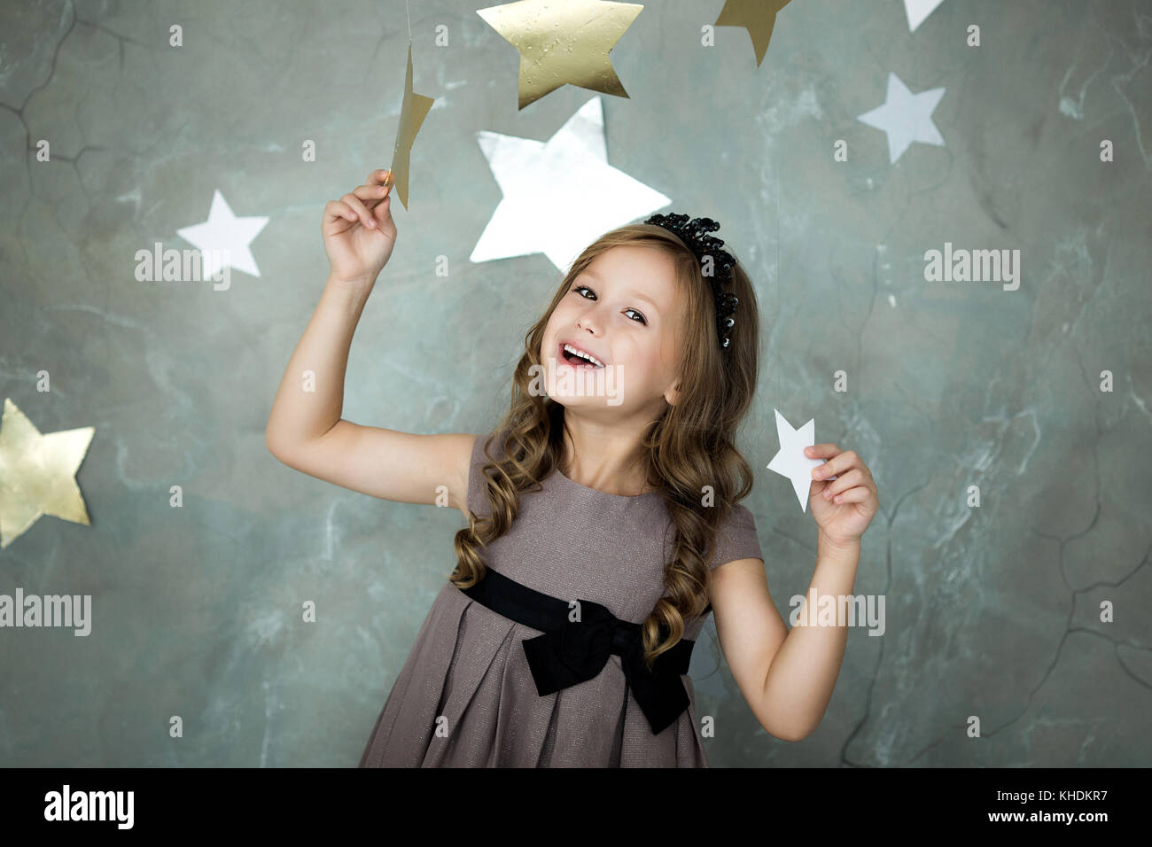 portrait of a happy little girl on a background of stars Stock Photo ...