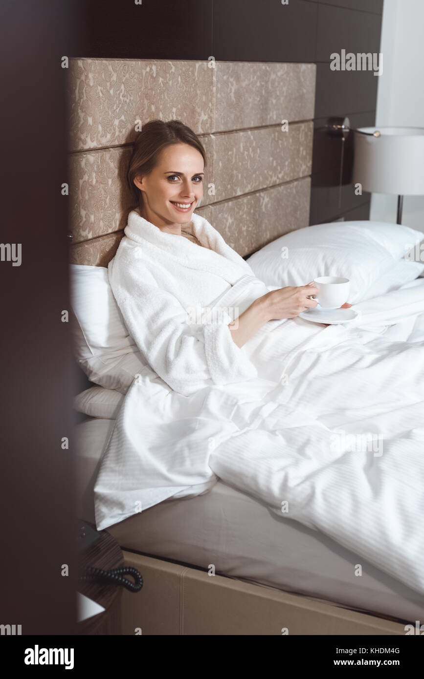 woman in bathrobe drinking coffee Stock Photo - Alamy