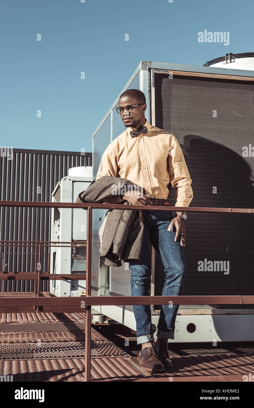 Handsome man holding jacket Stock Photo - Alamy