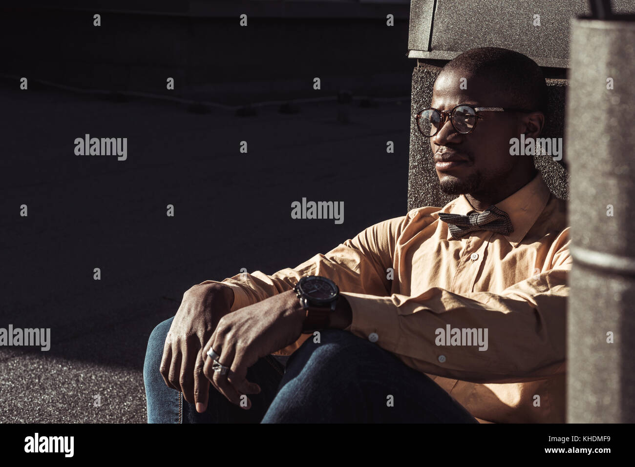 african american man sitting on rooftop Stock Photo - Alamy