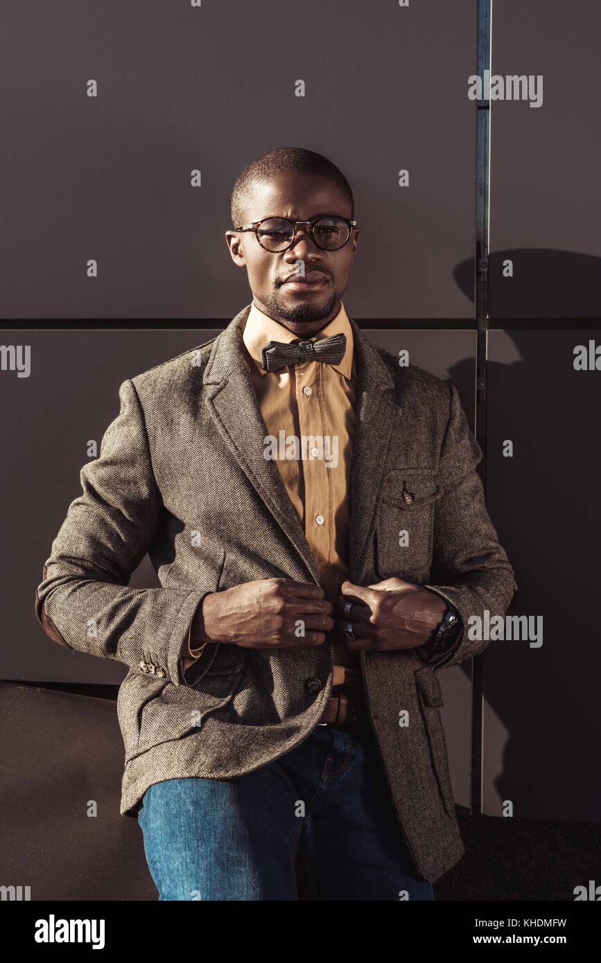 Stylish african american man adjusting jacket Stock Photo - Alamy