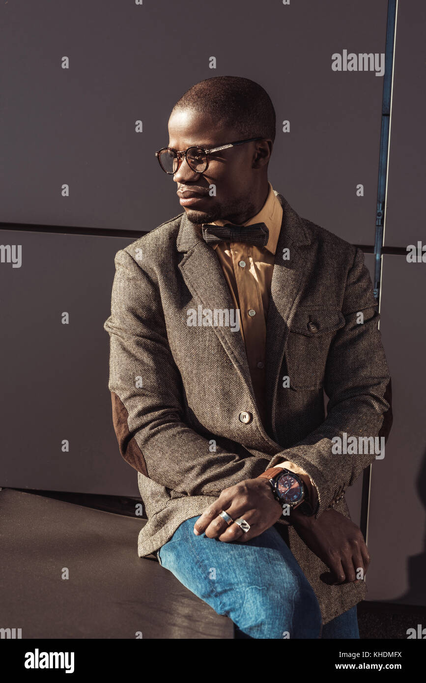 Stylish man in suit sitting on concrete Stock Photo - Alamy