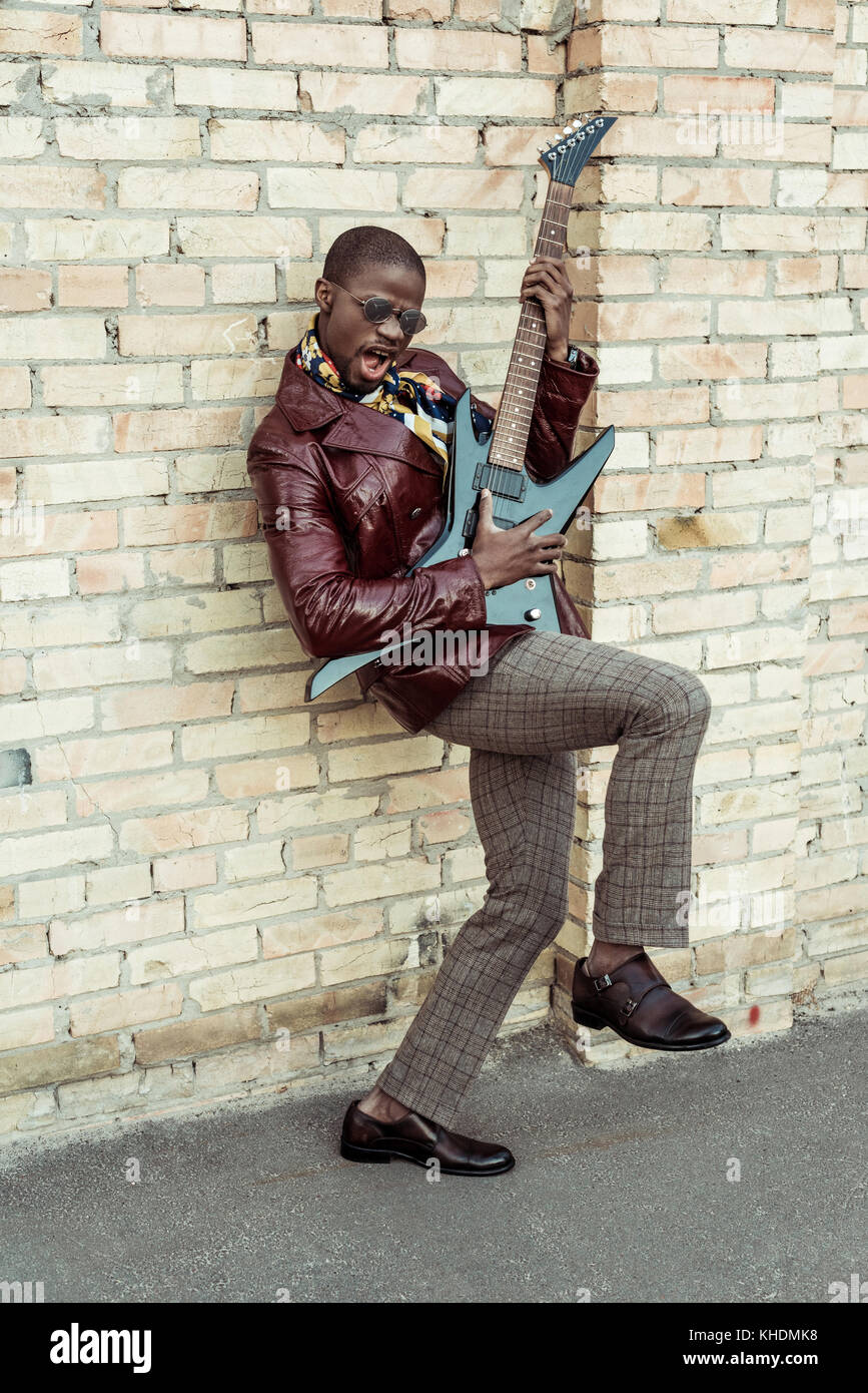 Handsome african american man playing guitar Stock Photo - Alamy