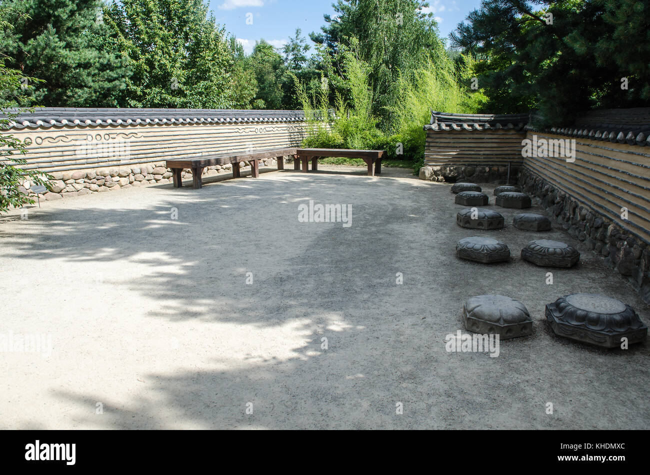 old korean garden with benches and a traditional stone wall Stock Photo ...