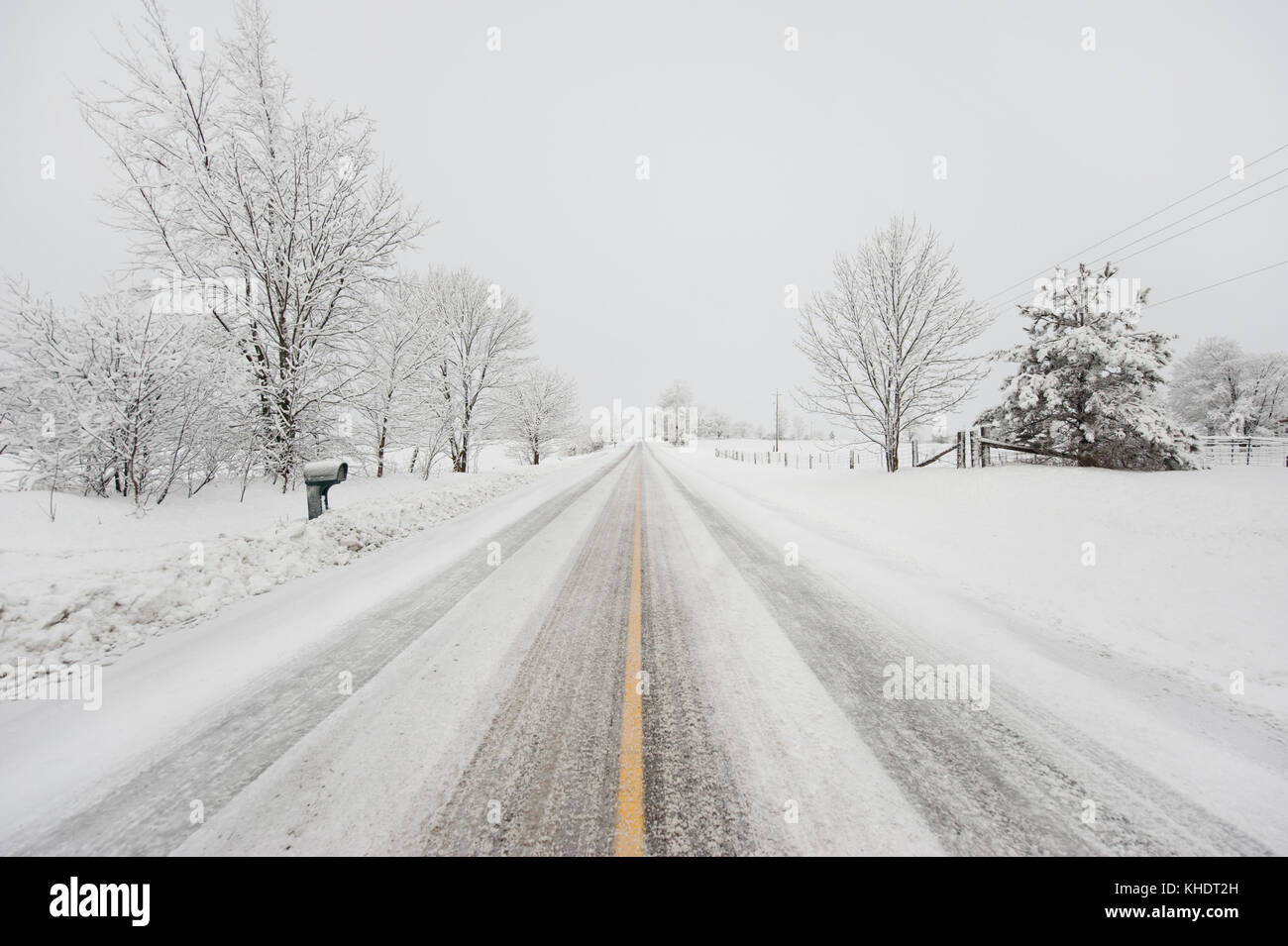 View of snow covered road from middle of road after a large snowfall in ...