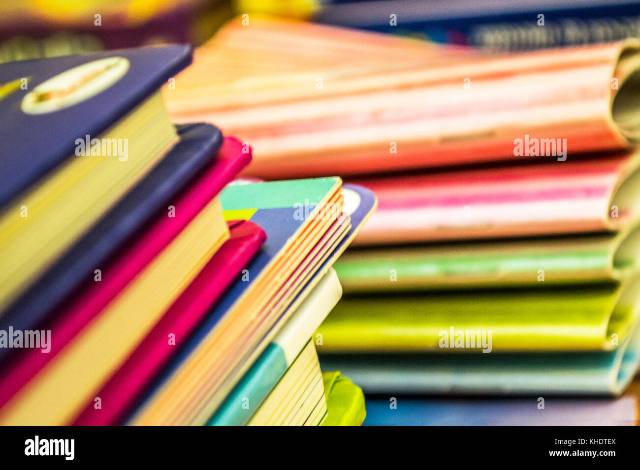 Many piles of very colored children books Stock Photo - Alamy