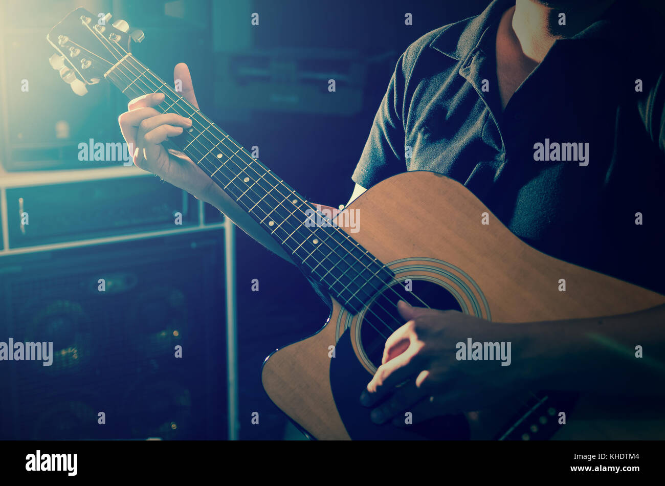 Closeup musician playing the guitar on band background with spot light ...
