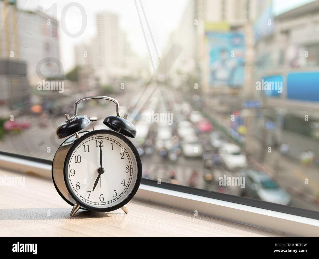 Vintage alarm clock at windows with abstract Blurred photo of traffic ...