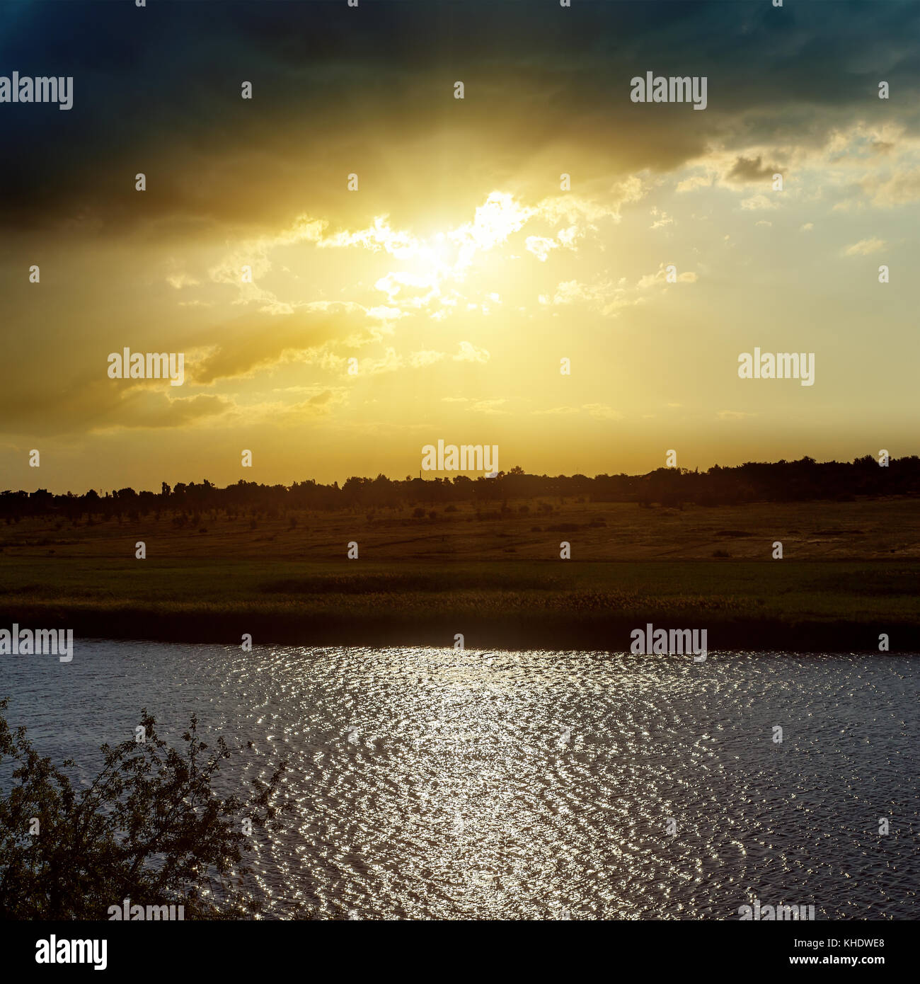 dramatic yellow sunset over river Stock Photo - Alamy