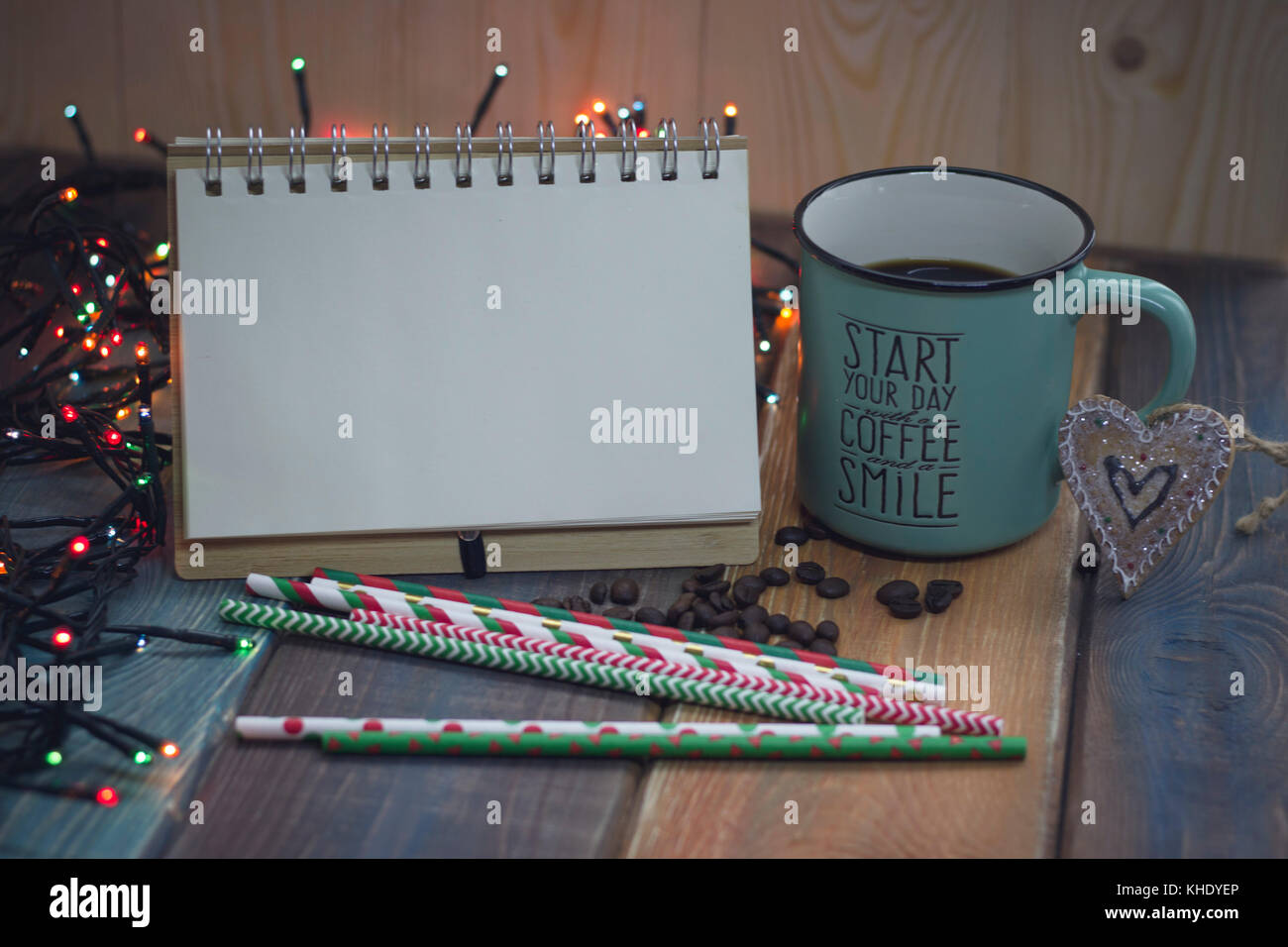 Notepad, blue cup and sweet sticks on a wooden table Stock Photo - Alamy