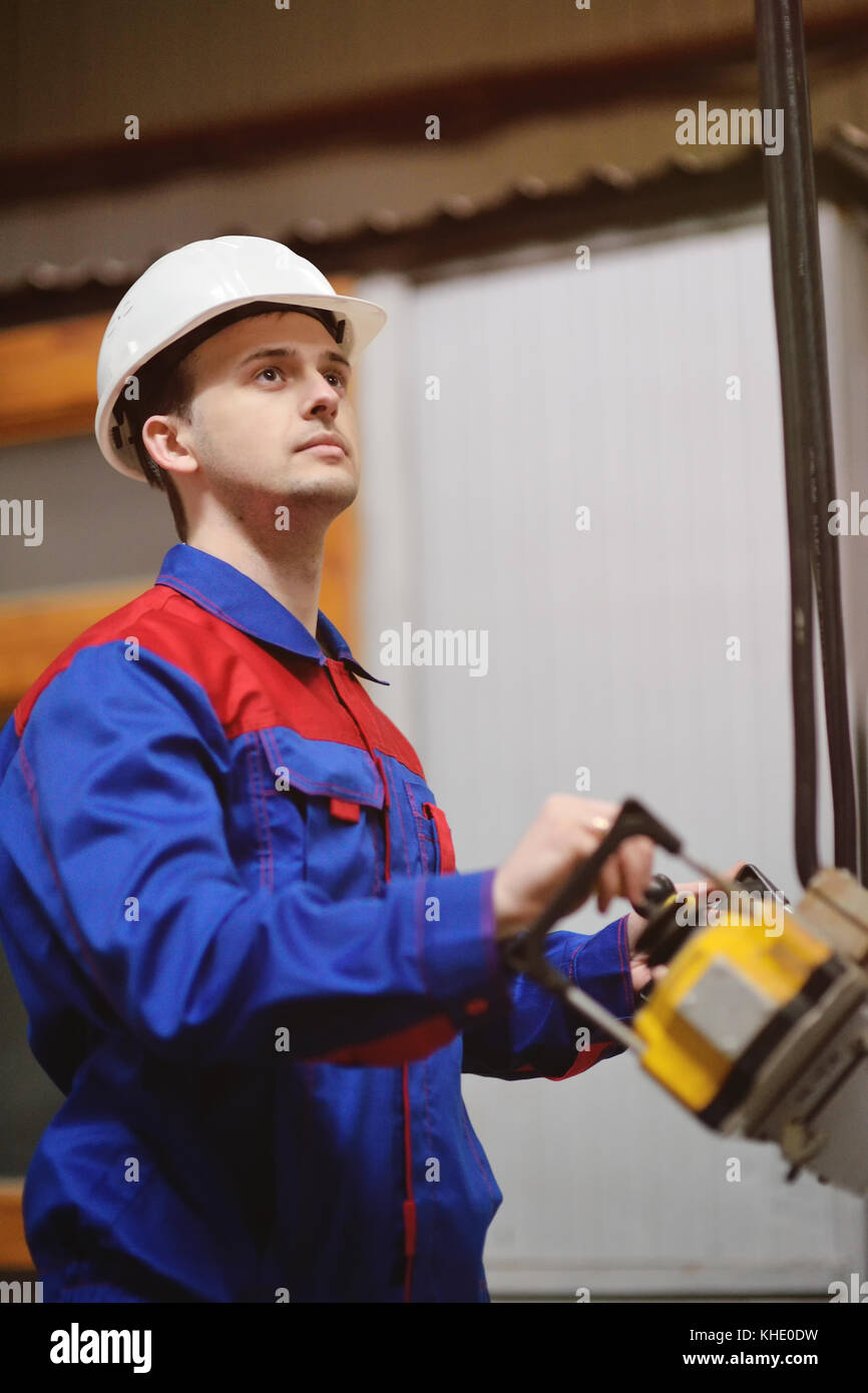 Man, factory, remote control in hands Stock Photo - Alamy