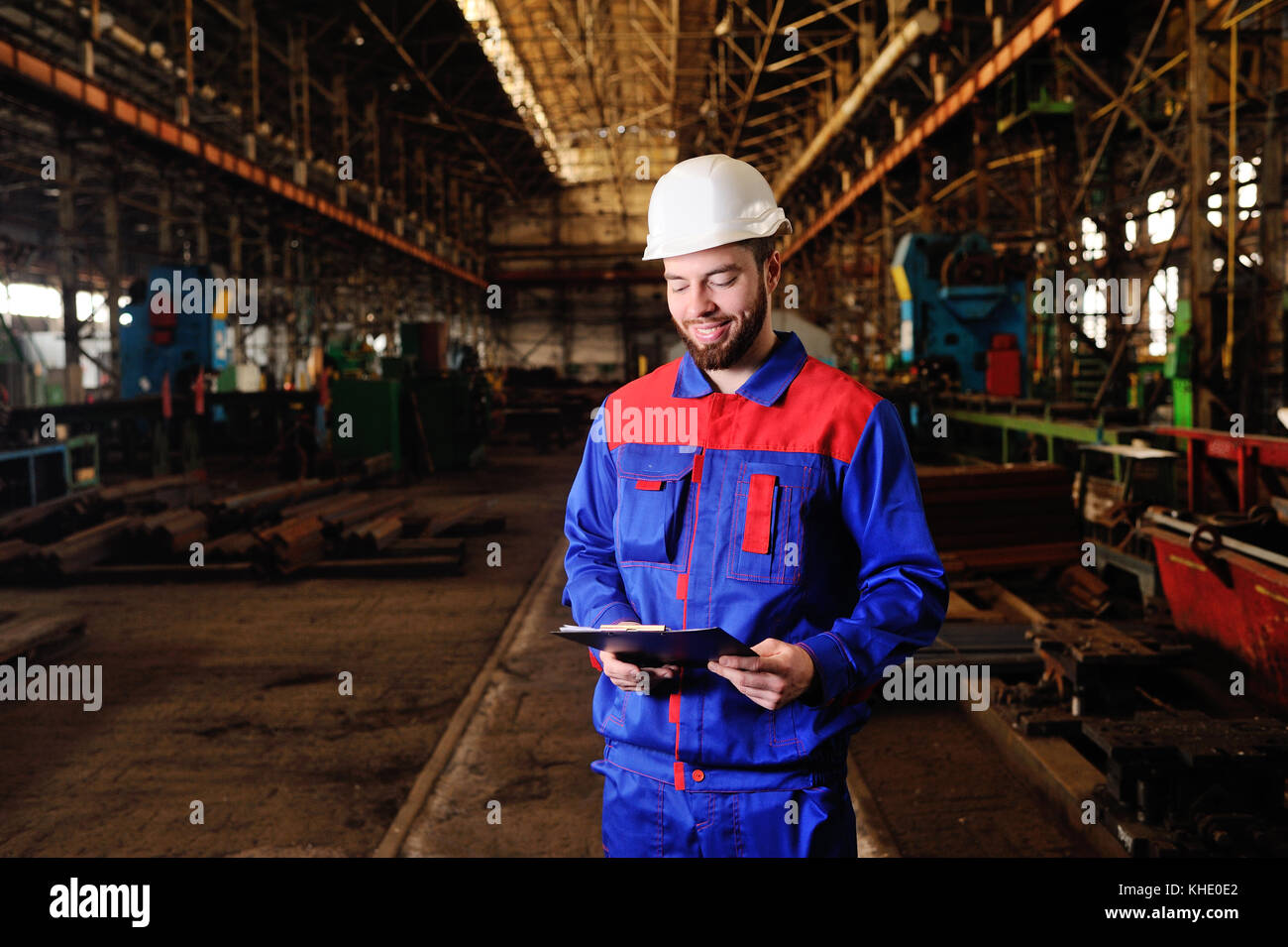 Worker in a helmet with a tablet Stock Photo - Alamy