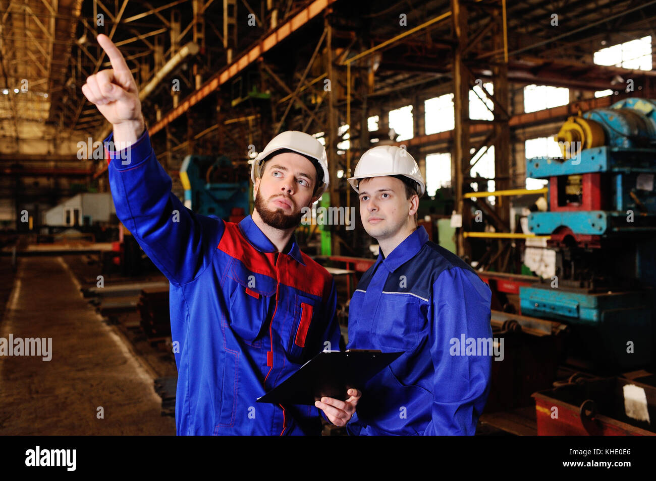 Two workers discuss a construction project Stock Photo - Alamy