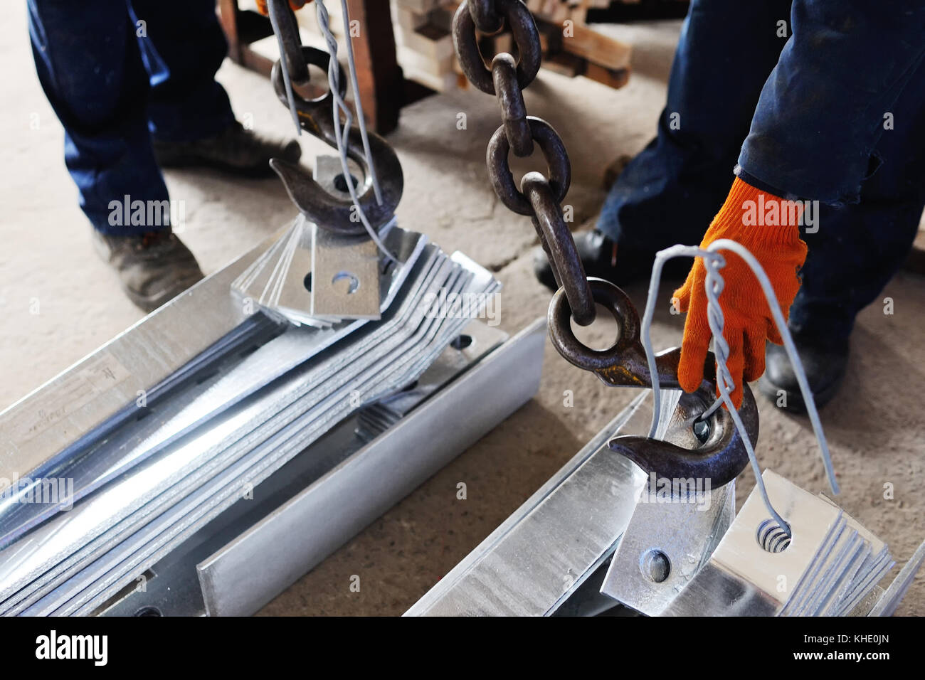 Workers load goods on the hook of the crane Stock Photo - Alamy