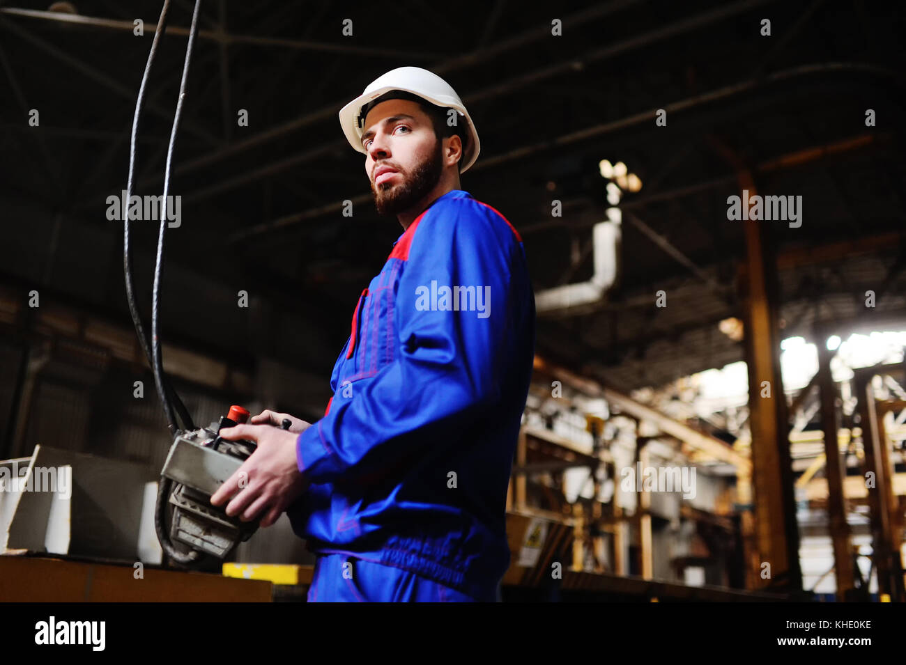 Man, factory, remote control in hands Stock Photo - Alamy