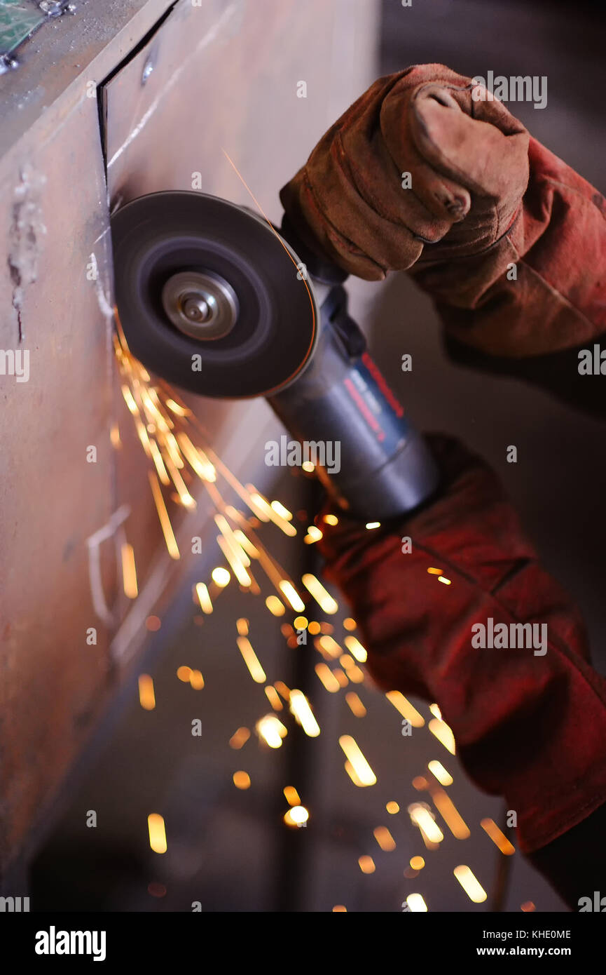 Worker with angle grinder Stock Photo - Alamy