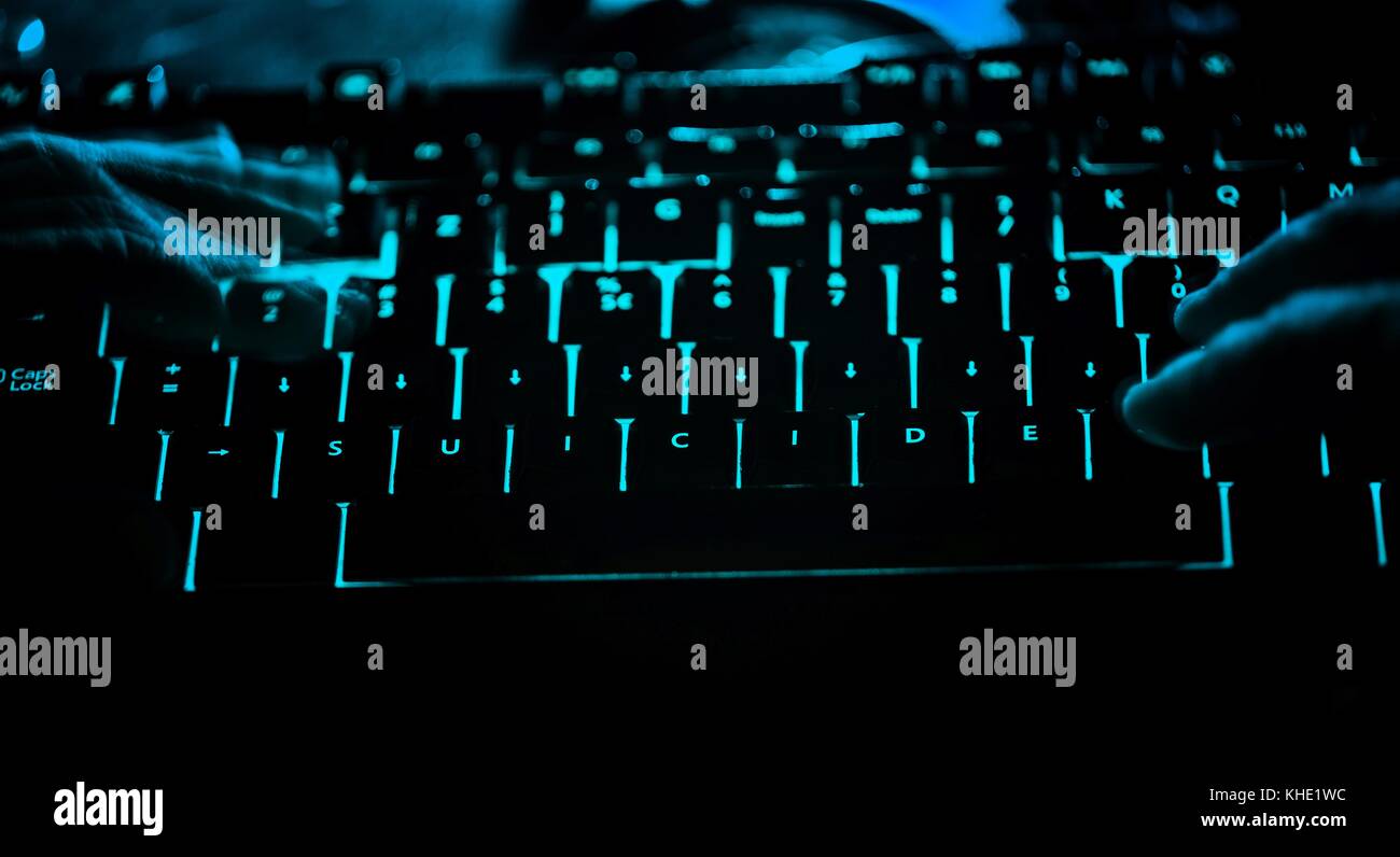Suicide - text on illuminated computer keyboard at night. Internet ...