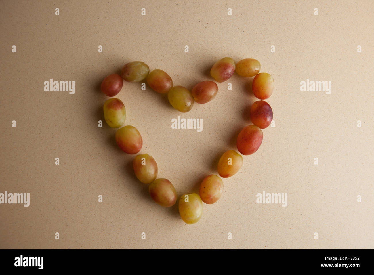 heart shape of red grape, closeup background Stock Photo - Alamy