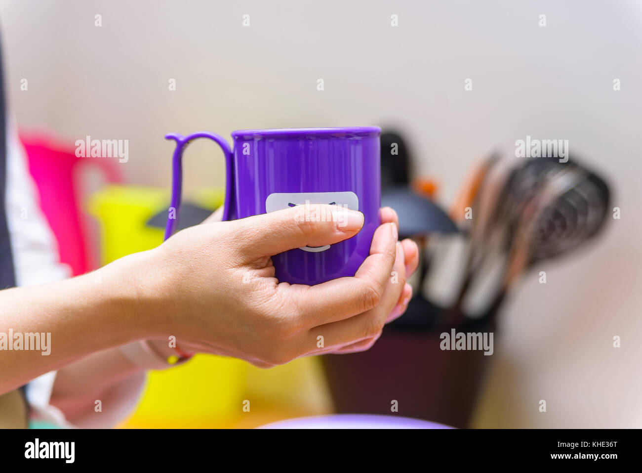 Hands hold plastic cup with smiling face Stock Photo - Alamy
