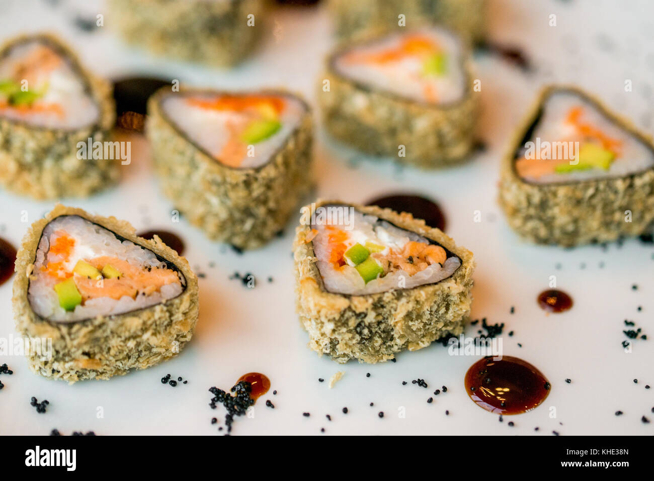 Close up delicious triangle sushi rolls on plate Stock Photo - Alamy