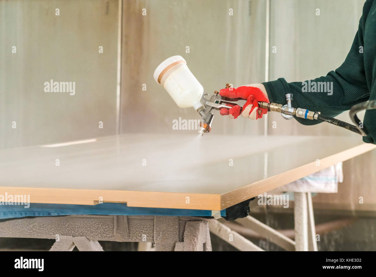 Staining wood with spray gun Stock Photo - Alamy