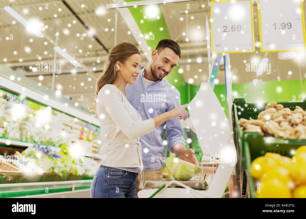happy couple weighing cabbage on scale at grocery Stock Photo - Alamy