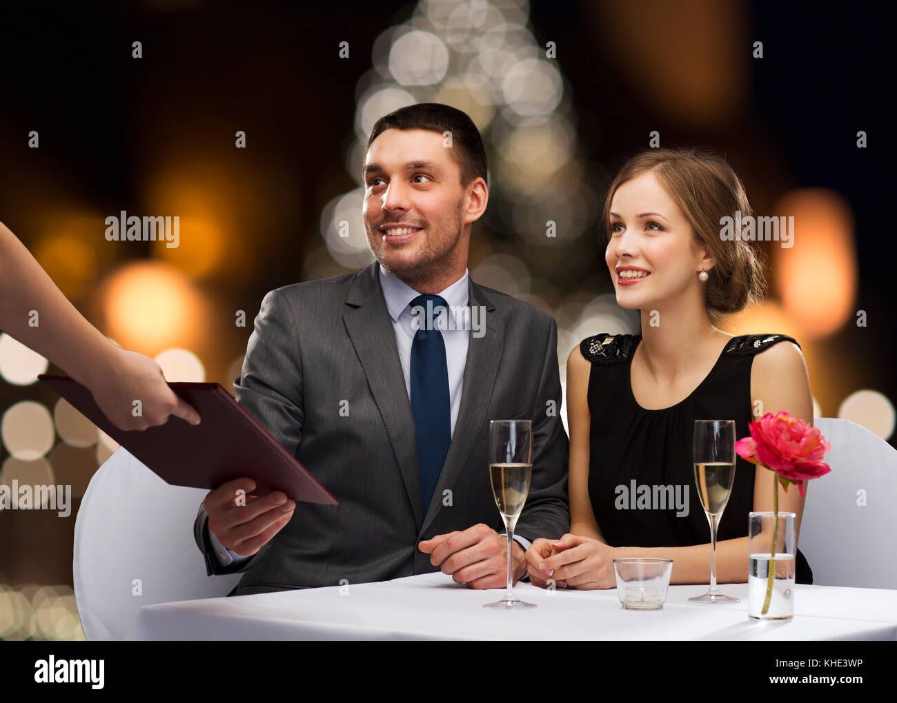 couple taking menu at christmas restaurant Stock Photo - Alamy