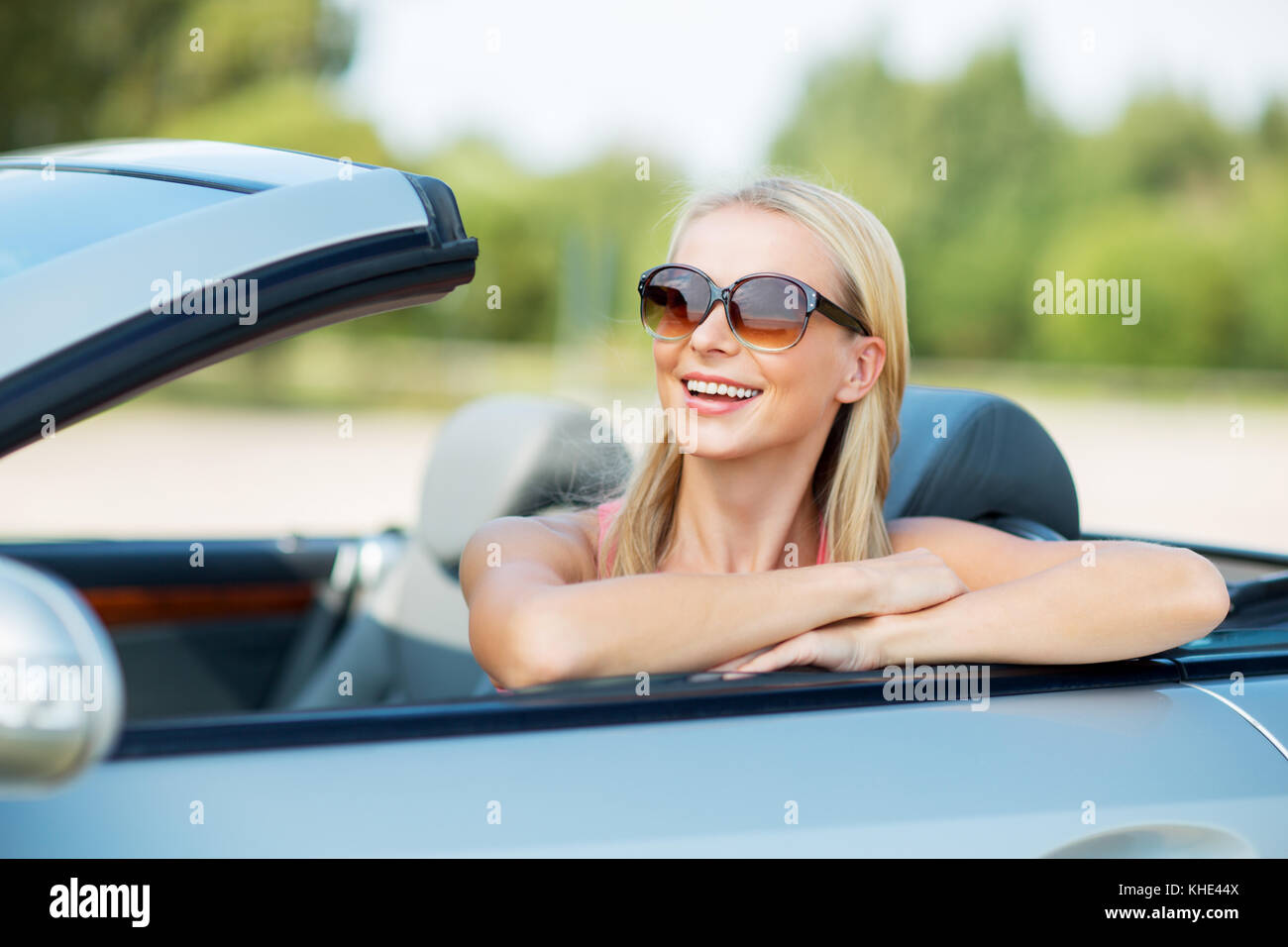 happy young woman in convertible car Stock Photo - Alamy