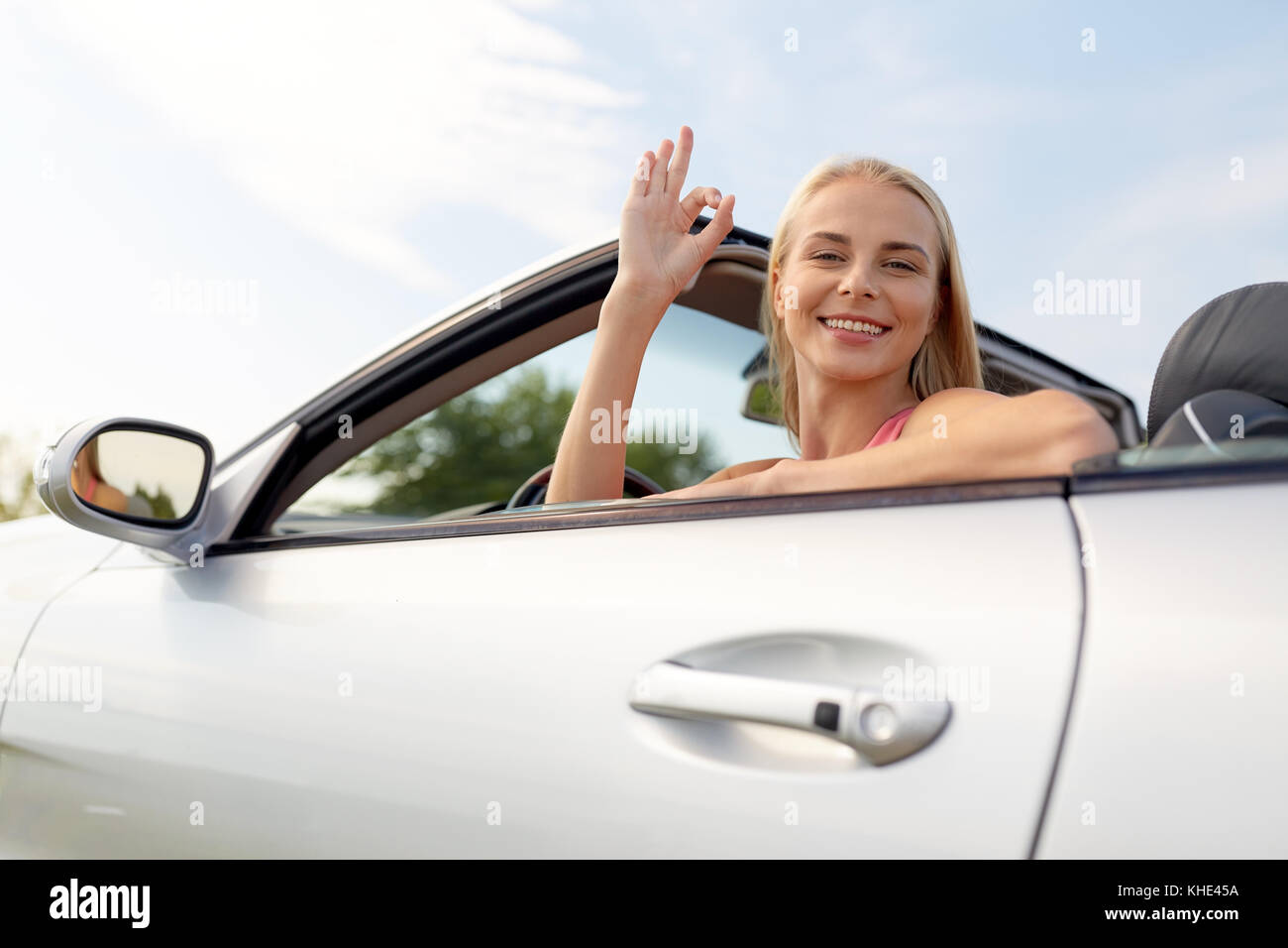 happy young woman in convertible car Stock Photo - Alamy