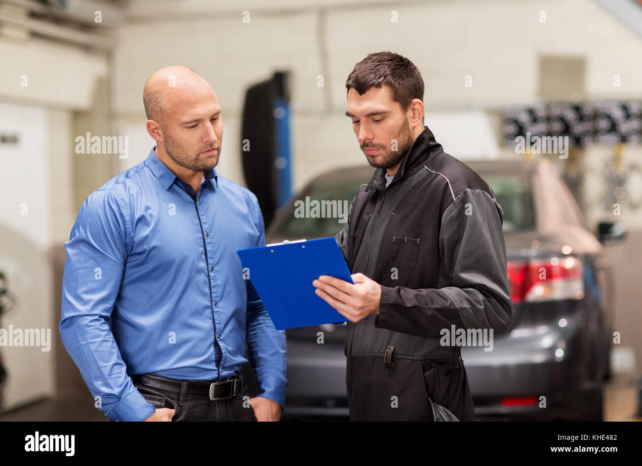 auto mechanic and customer at car shop Stock Photo - Alamy