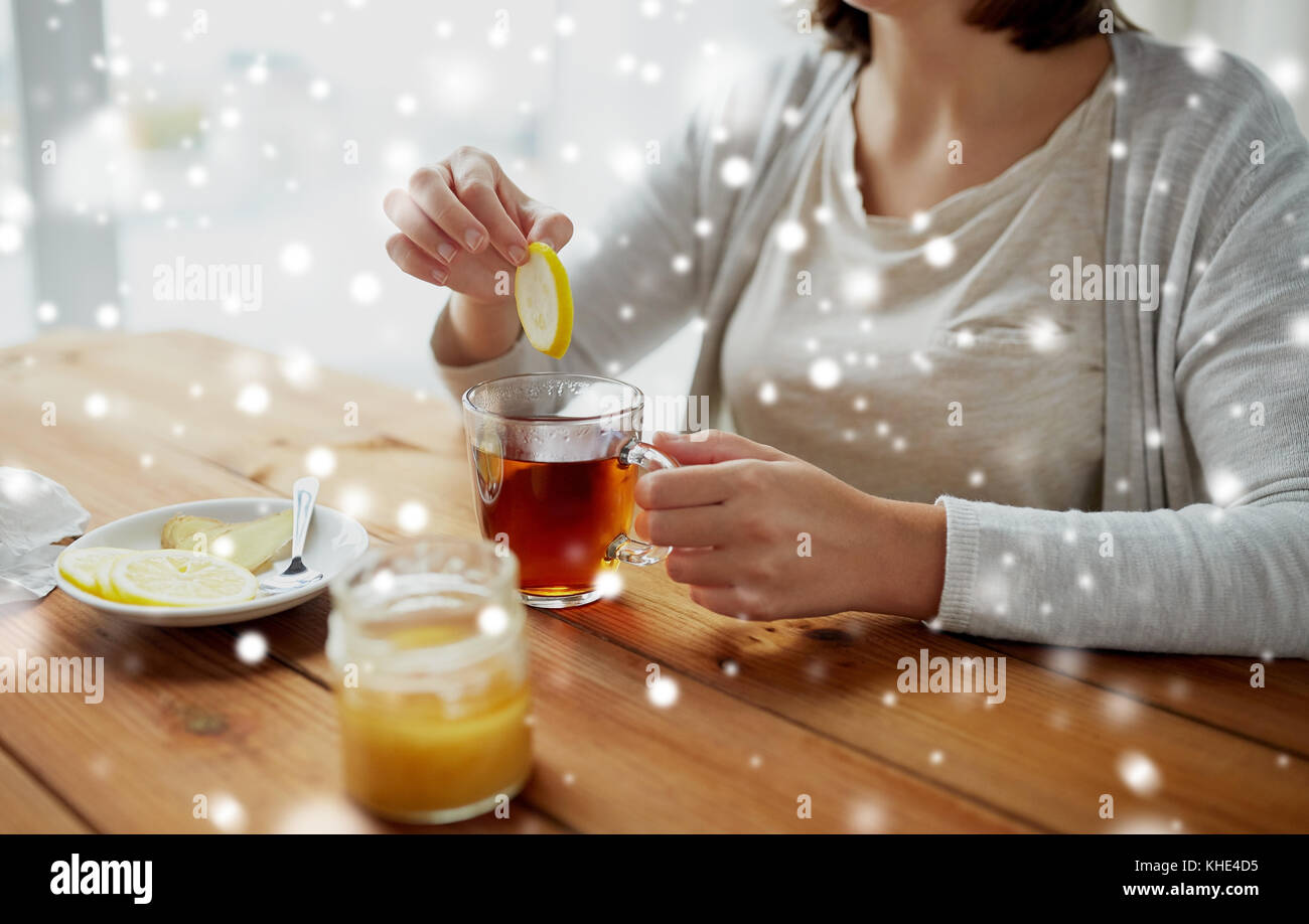 close up of woman adding honey to tea with lemon Stock Photo - Alamy