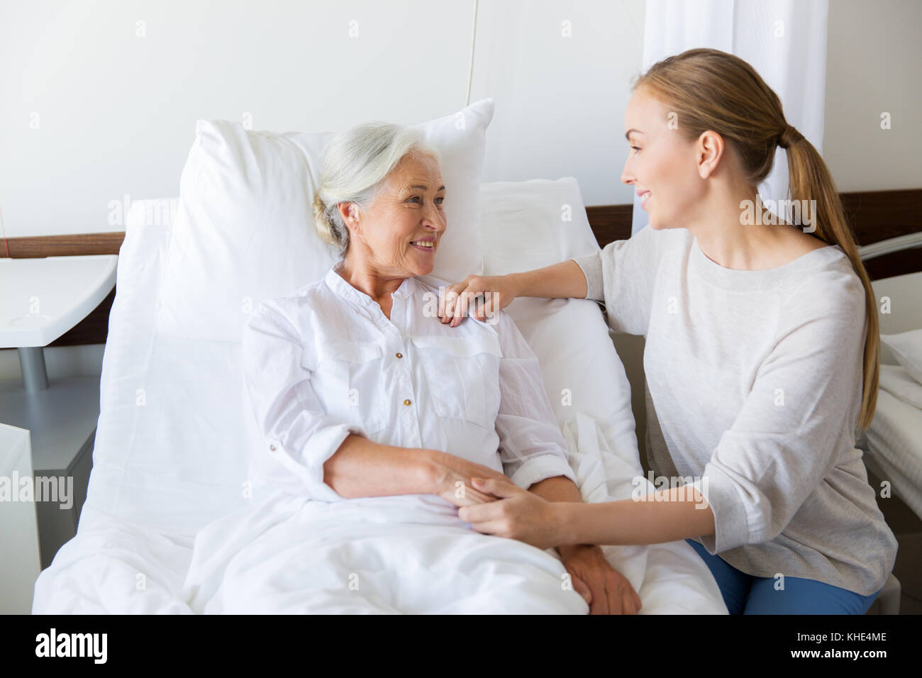 daughter visiting senior mother at hospital Stock Photo - Alamy