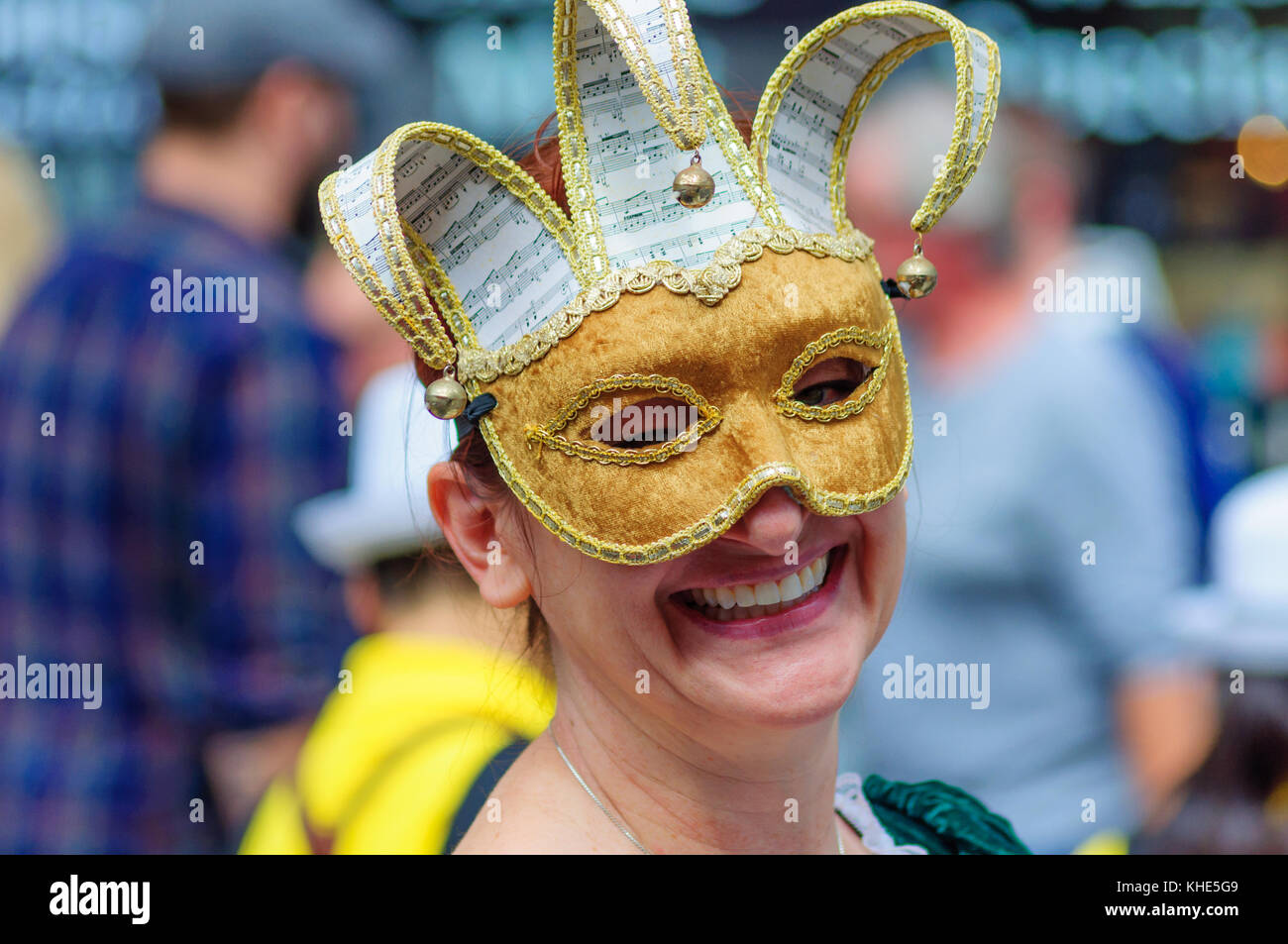 Female performer with red hair wearing a mask on the Royal Mile during ...