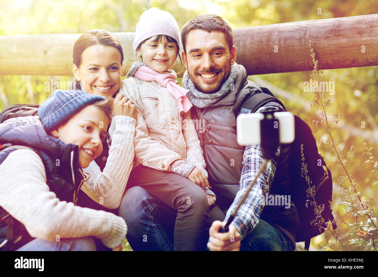 family with backpacks taking selfie and hiking Stock Photo - Alamy