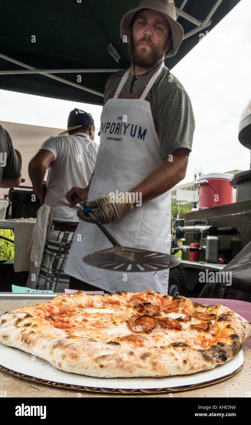 Timber Pizza Company co-owner Chris Brady slides an oven fresh bubbling ...