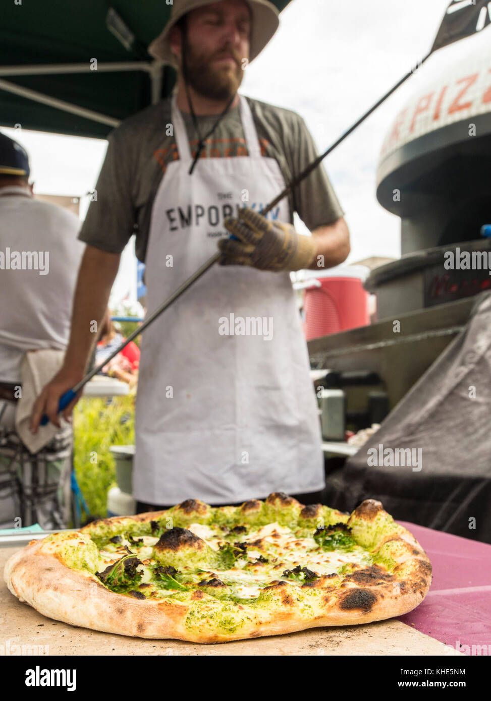 Timber Pizza Company co-owner Chris Brady slides an oven fresh bubbling ...