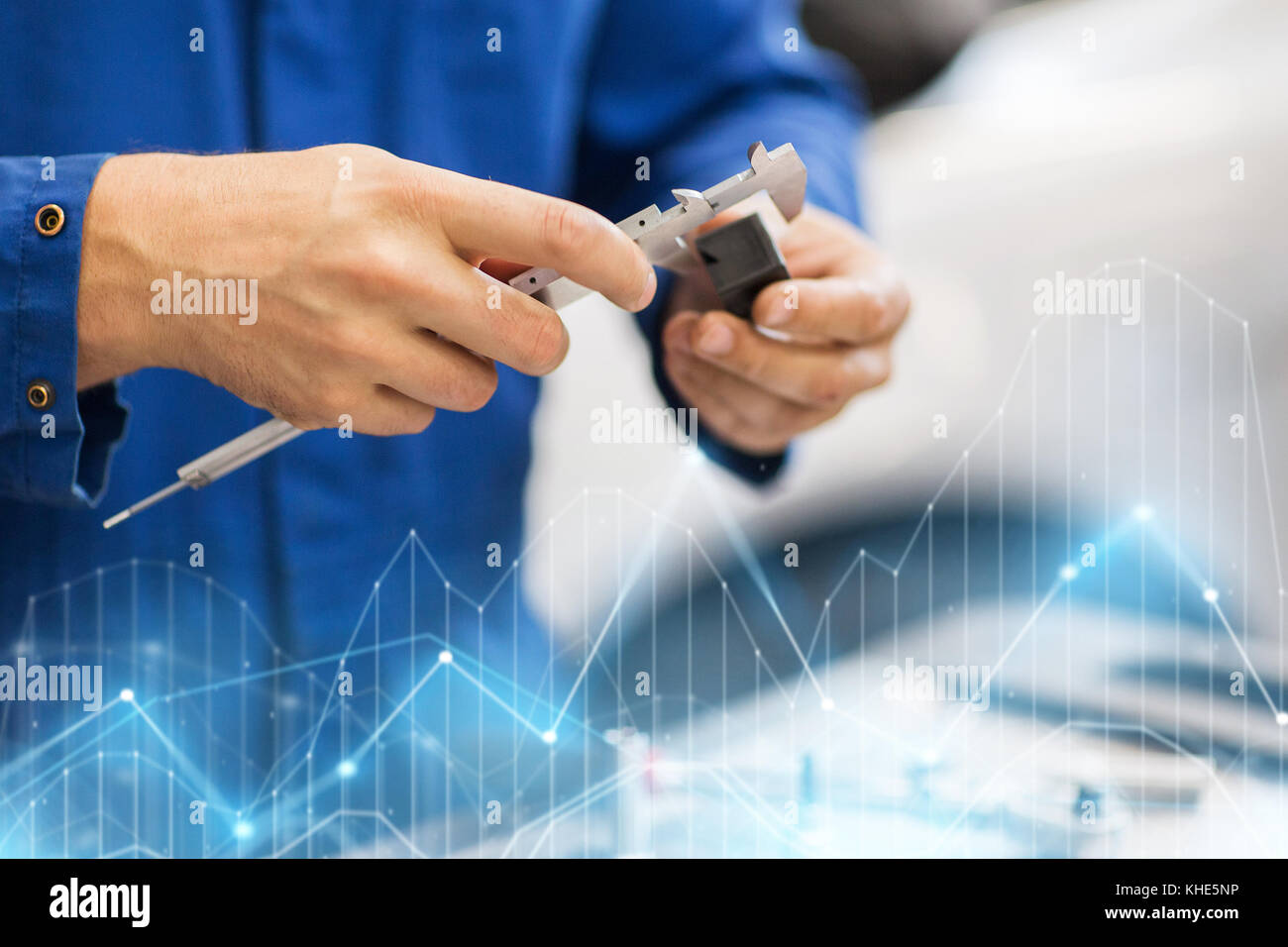 mechanic with calipers measures detail at workshop Stock Photo - Alamy