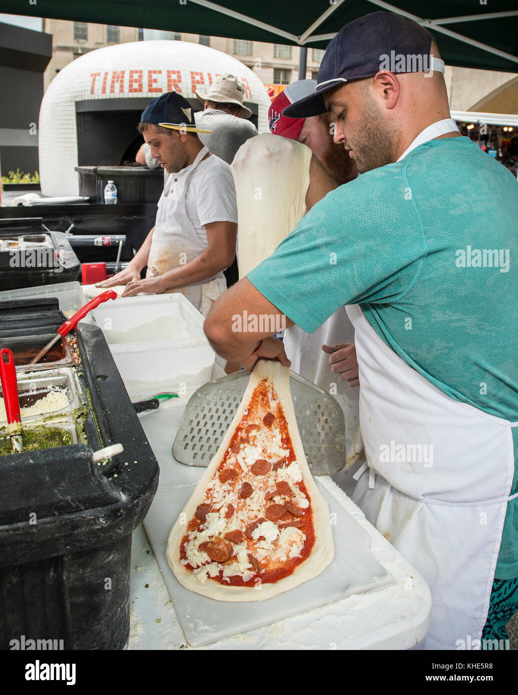 Timber Pizza Company co-owner Andrew Dana guides the strong stretchy ...