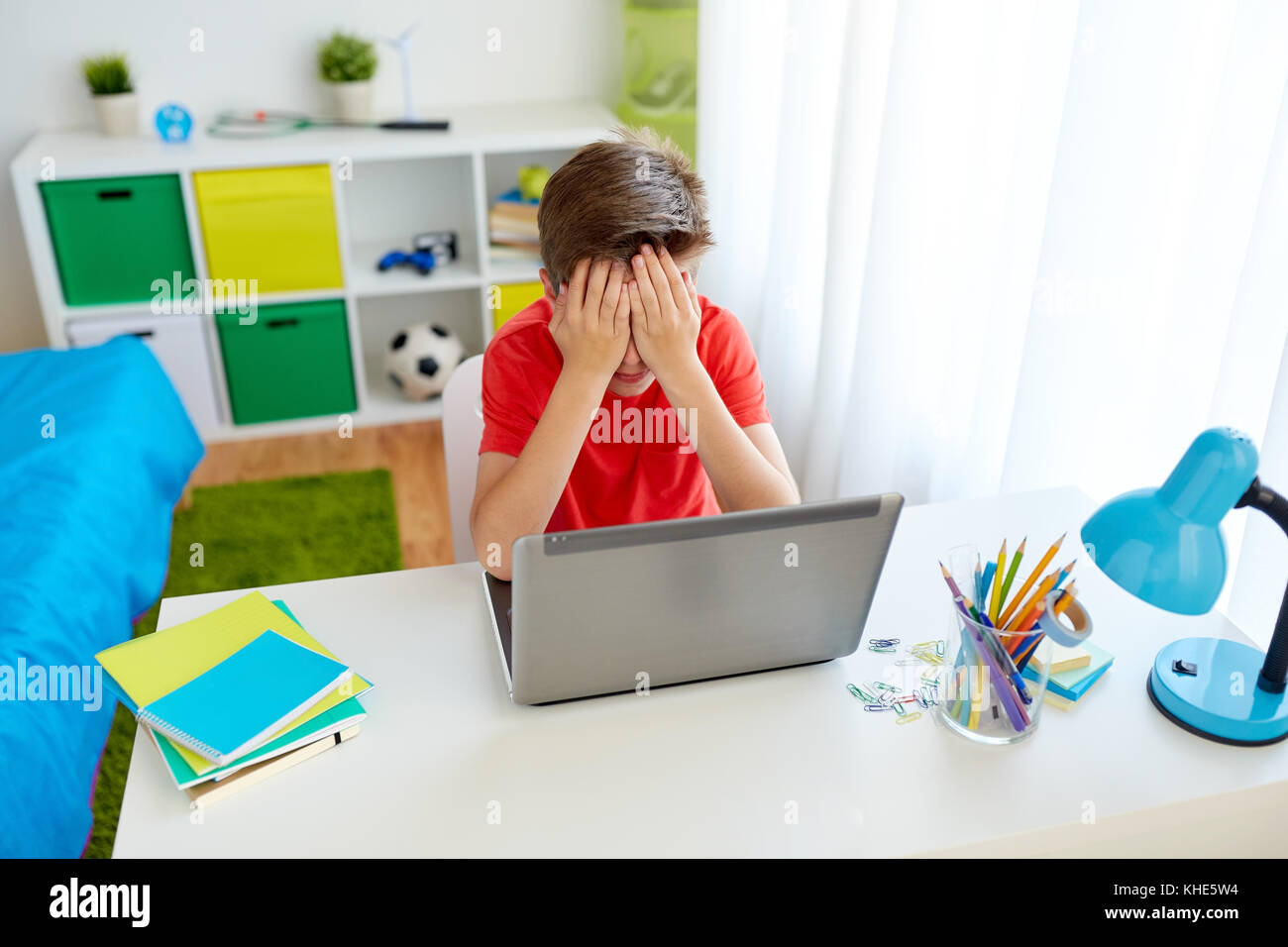 upset student boy with laptop computer at home Stock Photo - Alamy