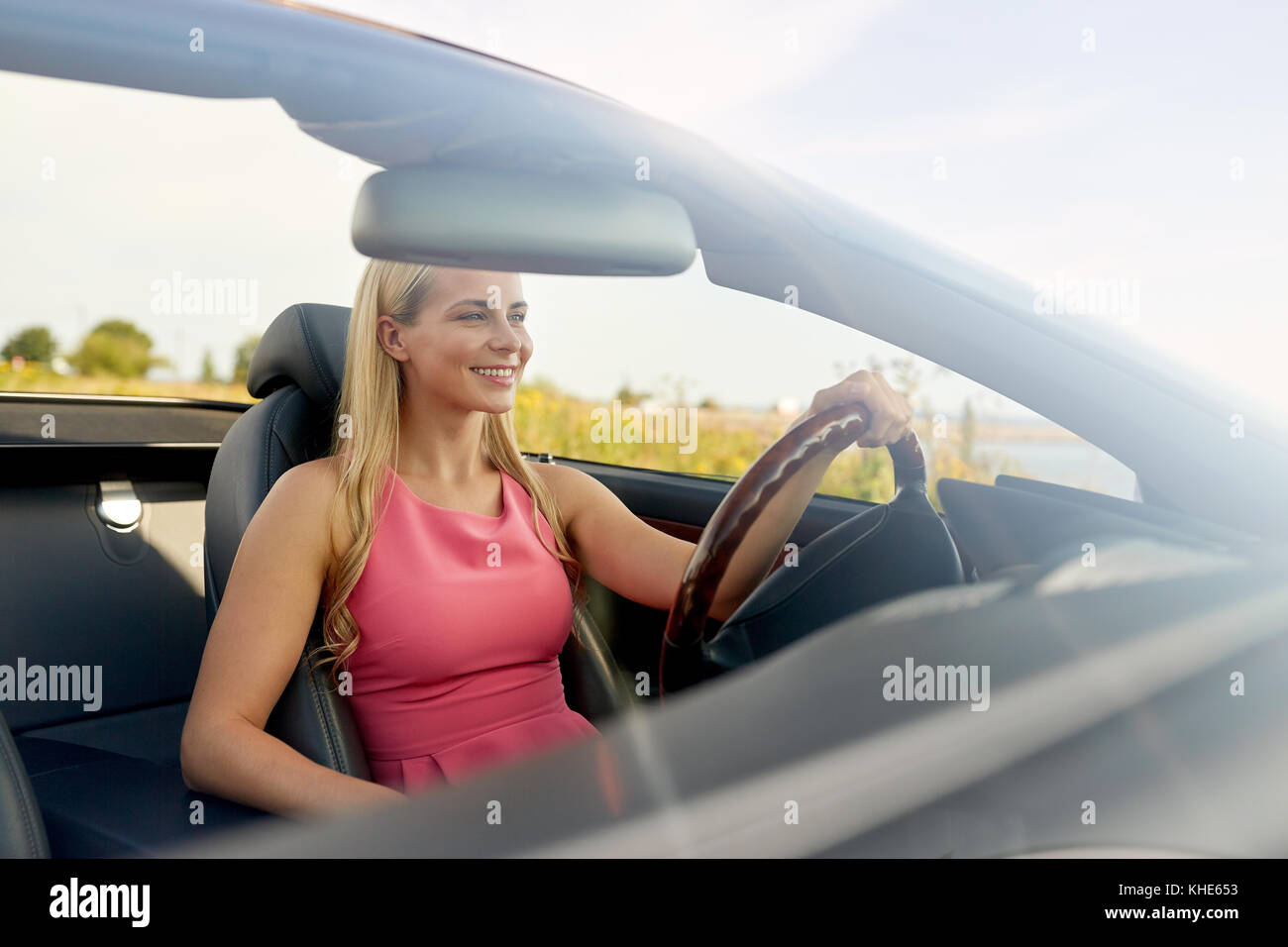 happy young woman driving convertible car Stock Photo - Alamy