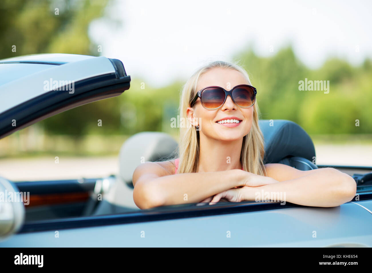 happy young woman in convertible car Stock Photo - Alamy