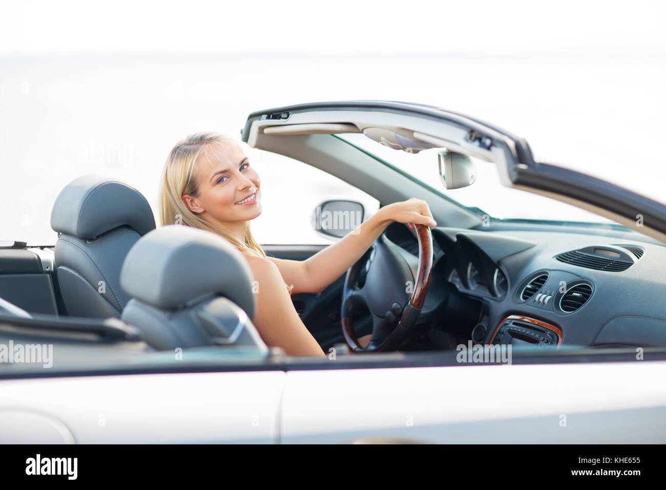 happy young woman driving convertible car Stock Photo - Alamy