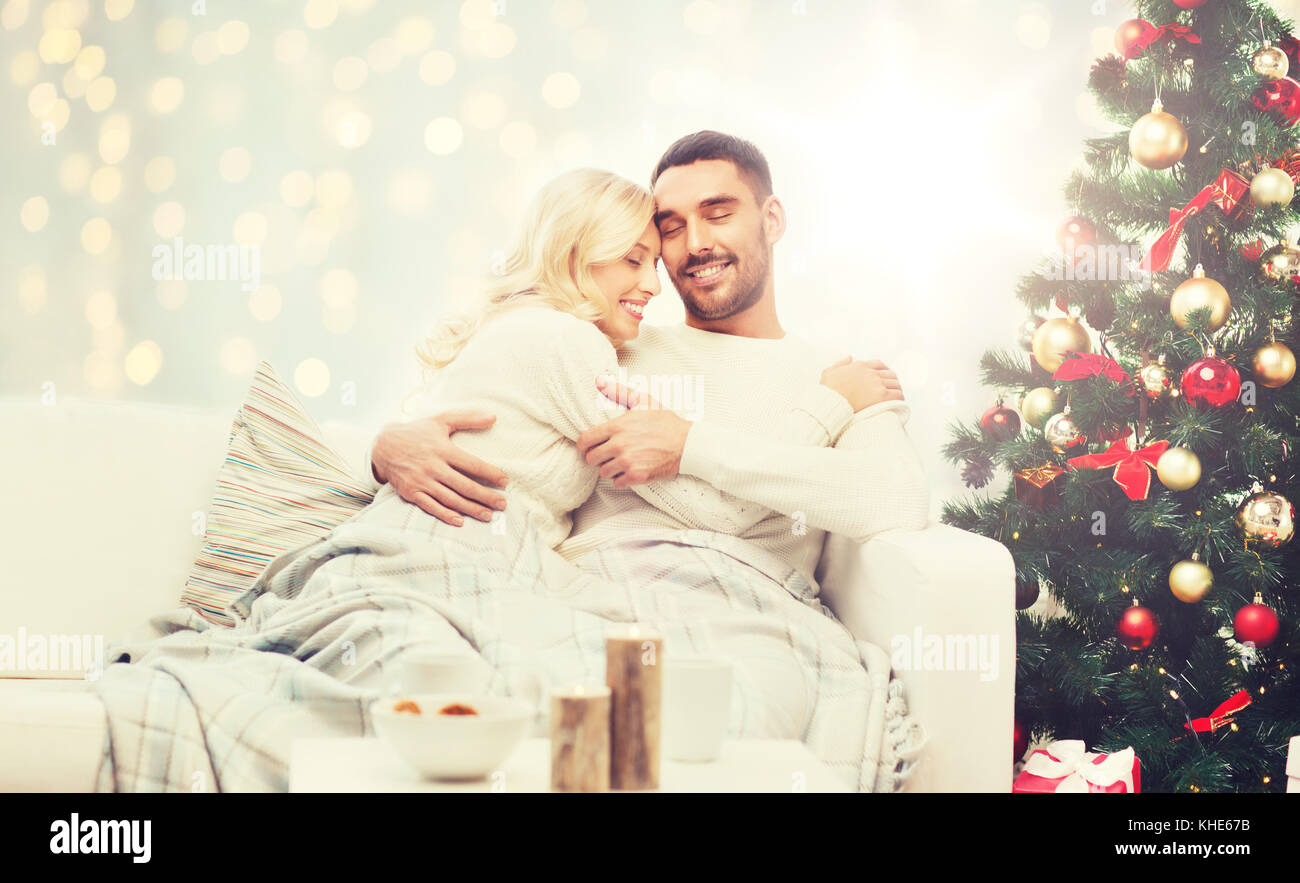 happy couple hugging over christmas tree Stock Photo - Alamy
