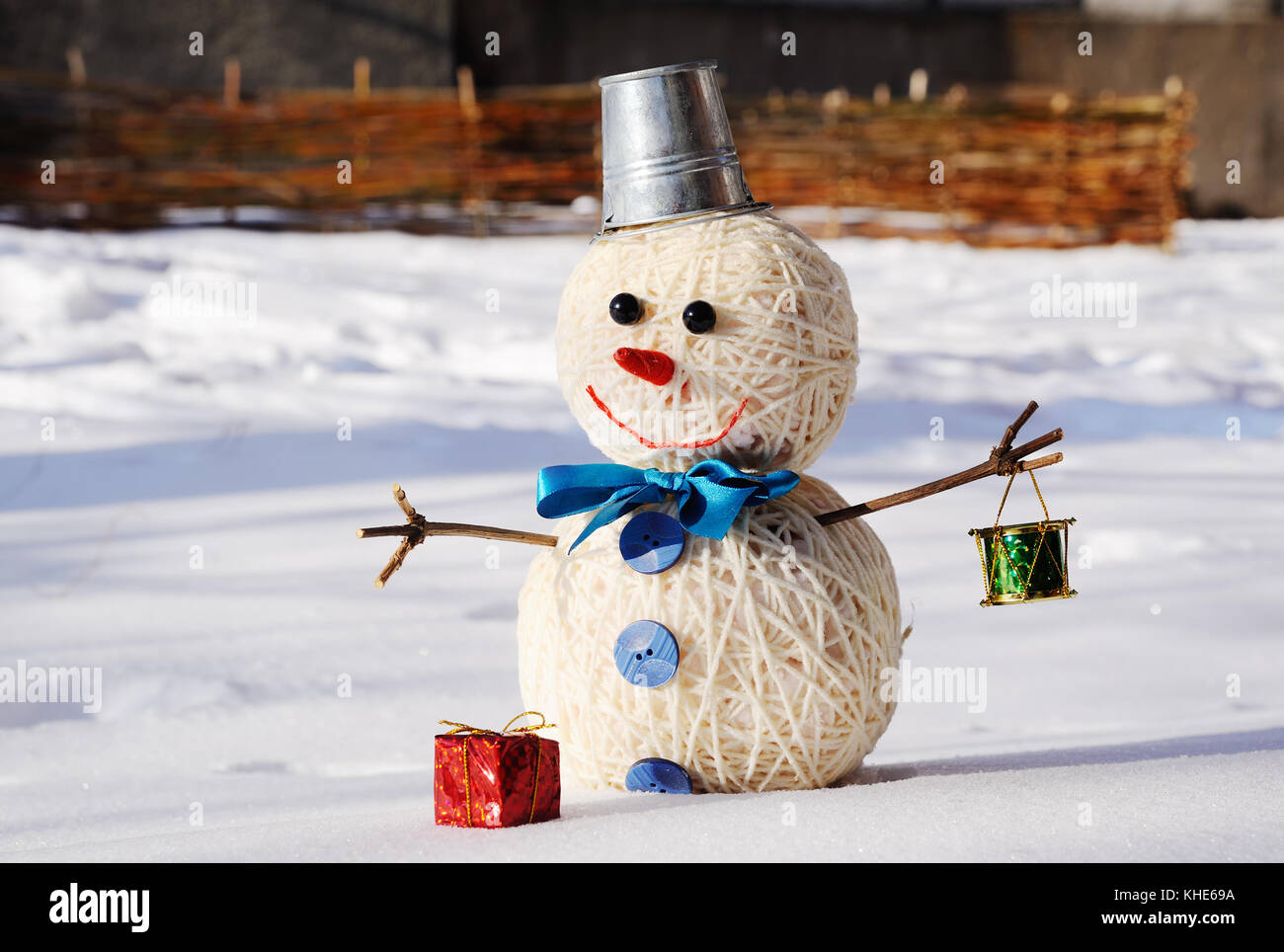 Snowman with a bucket on his head on a background of snow Stock Photo ...