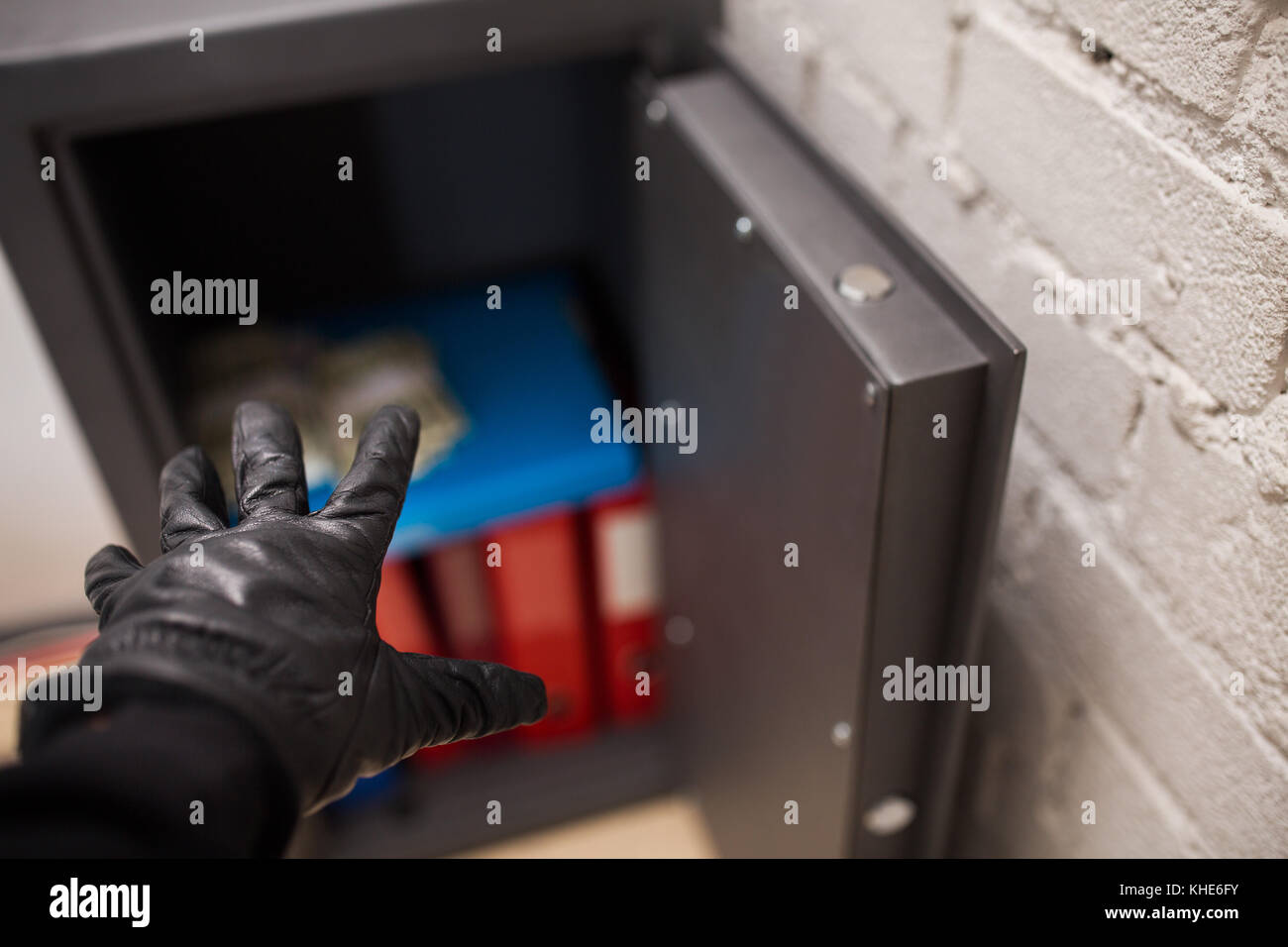 thief stealing valuables from safe at crime scene Stock Photo - Alamy