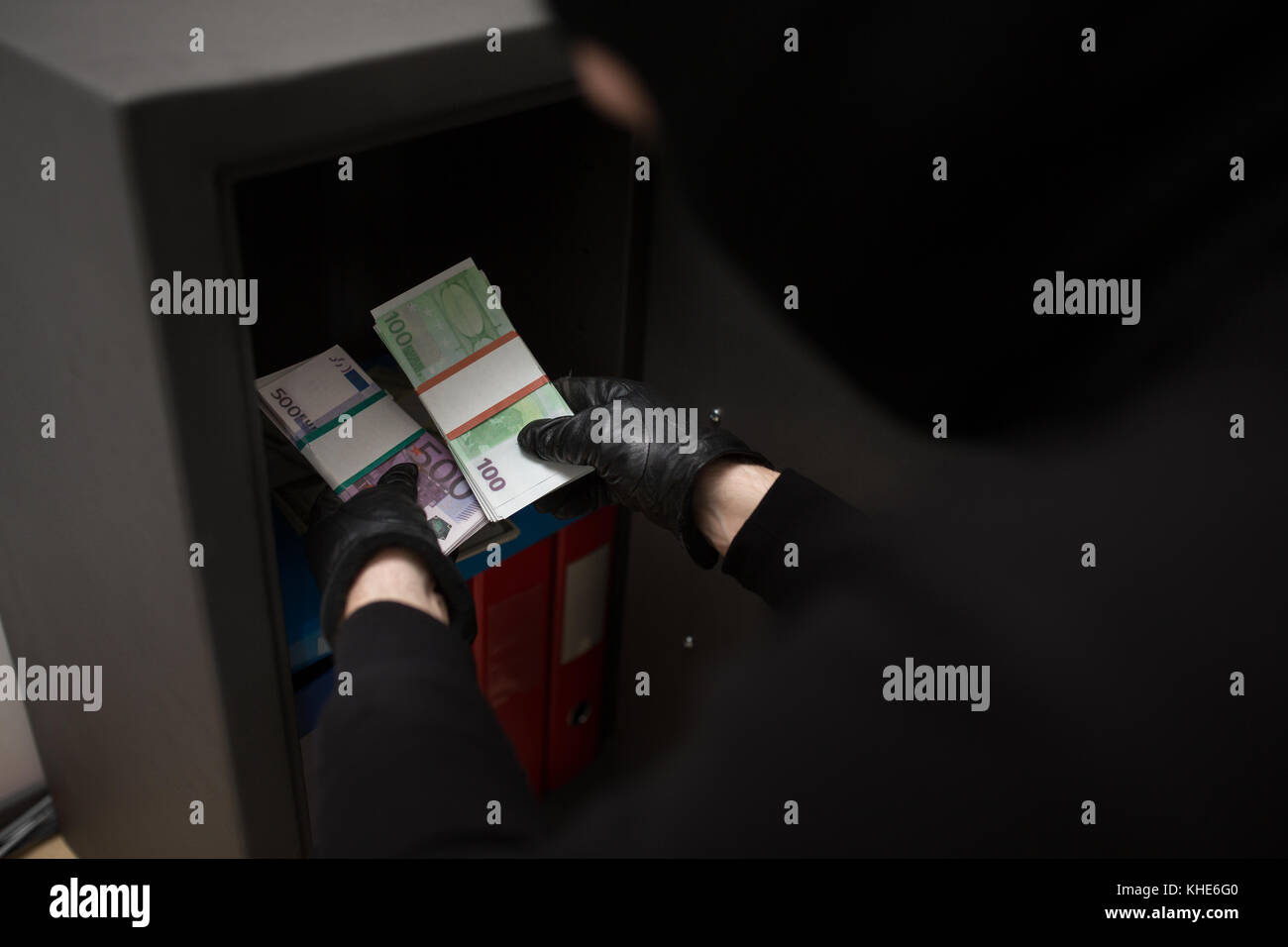 thief stealing money from safe at crime scene Stock Photo - Alamy
