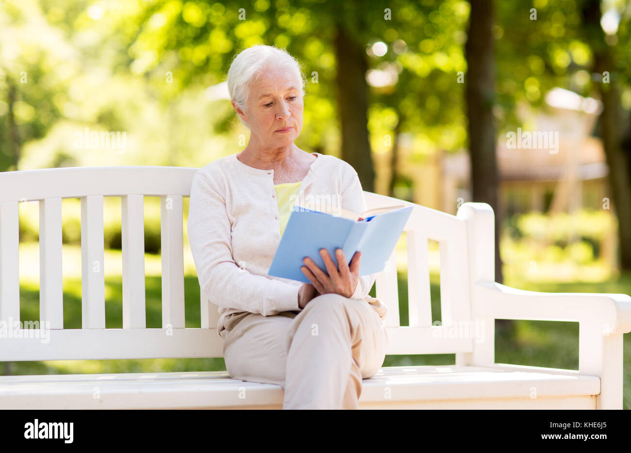 senior woman reading book at summer park Stock Photo - Alamy