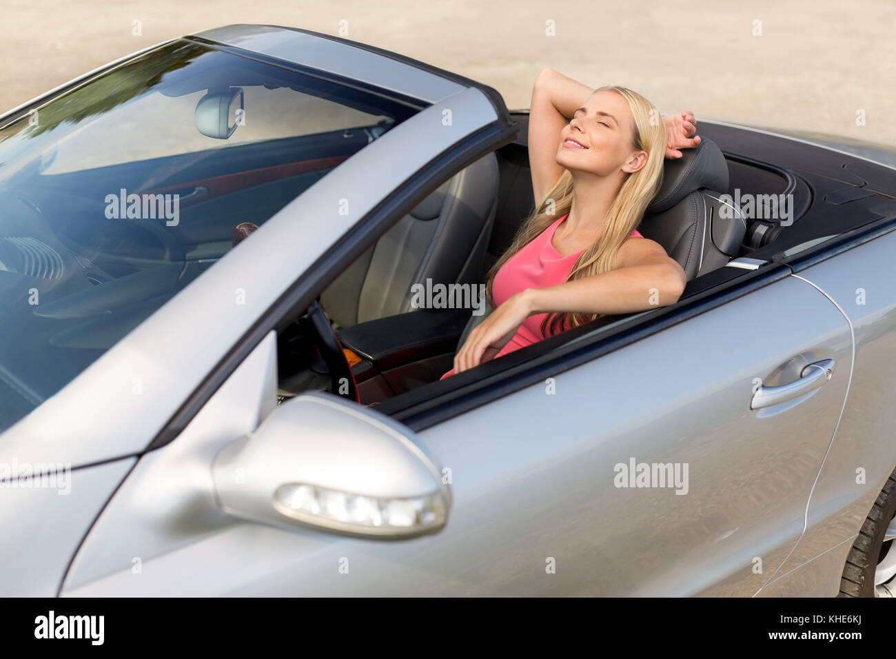 happy young woman in convertible car Stock Photo - Alamy