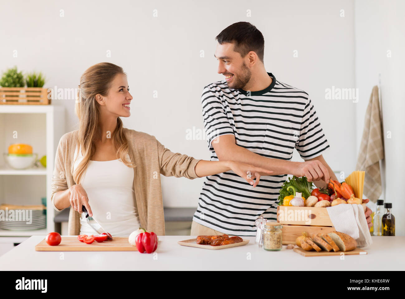 happy couple cooking food at home kitchen Stock Photo - Alamy