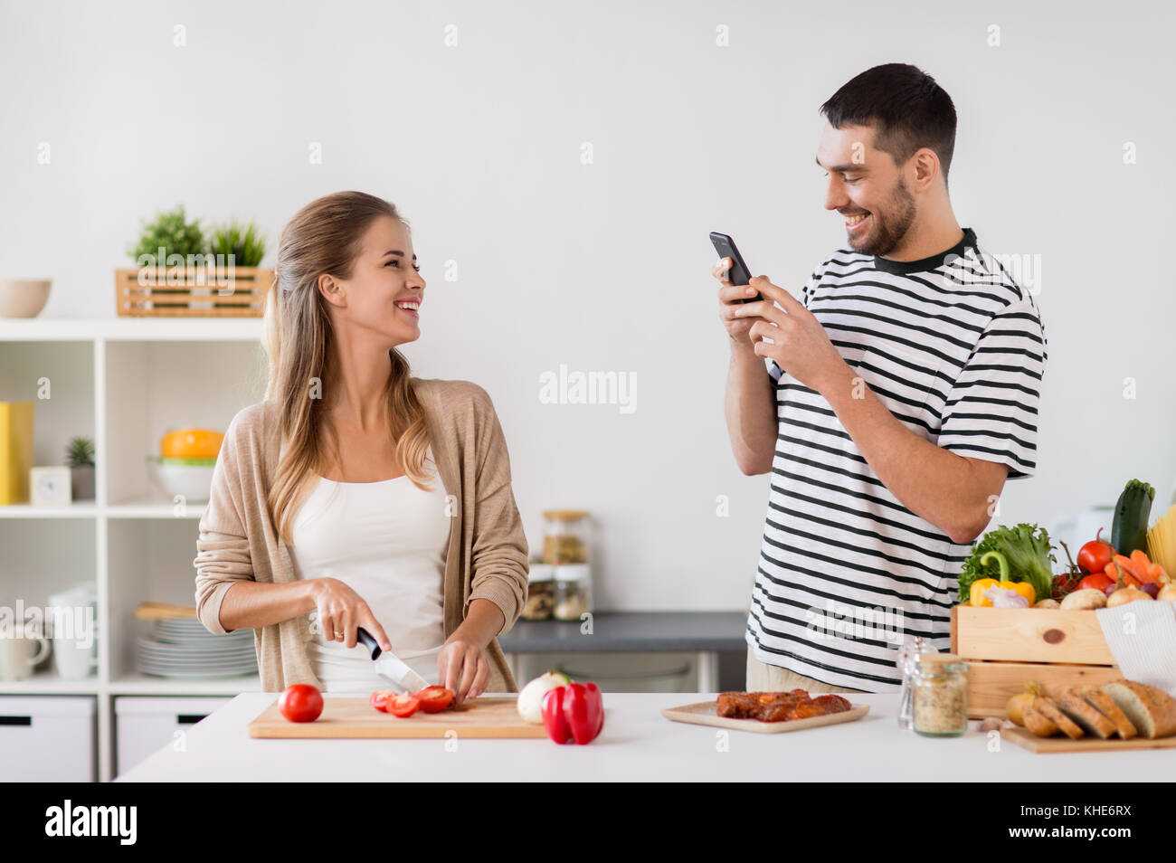 happy couple cooking food at home kitchen Stock Photo - Alamy